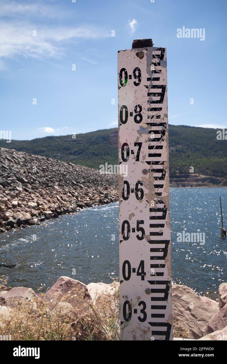 a weathered water level marker beside a reservoir Stock Photo - Alamy