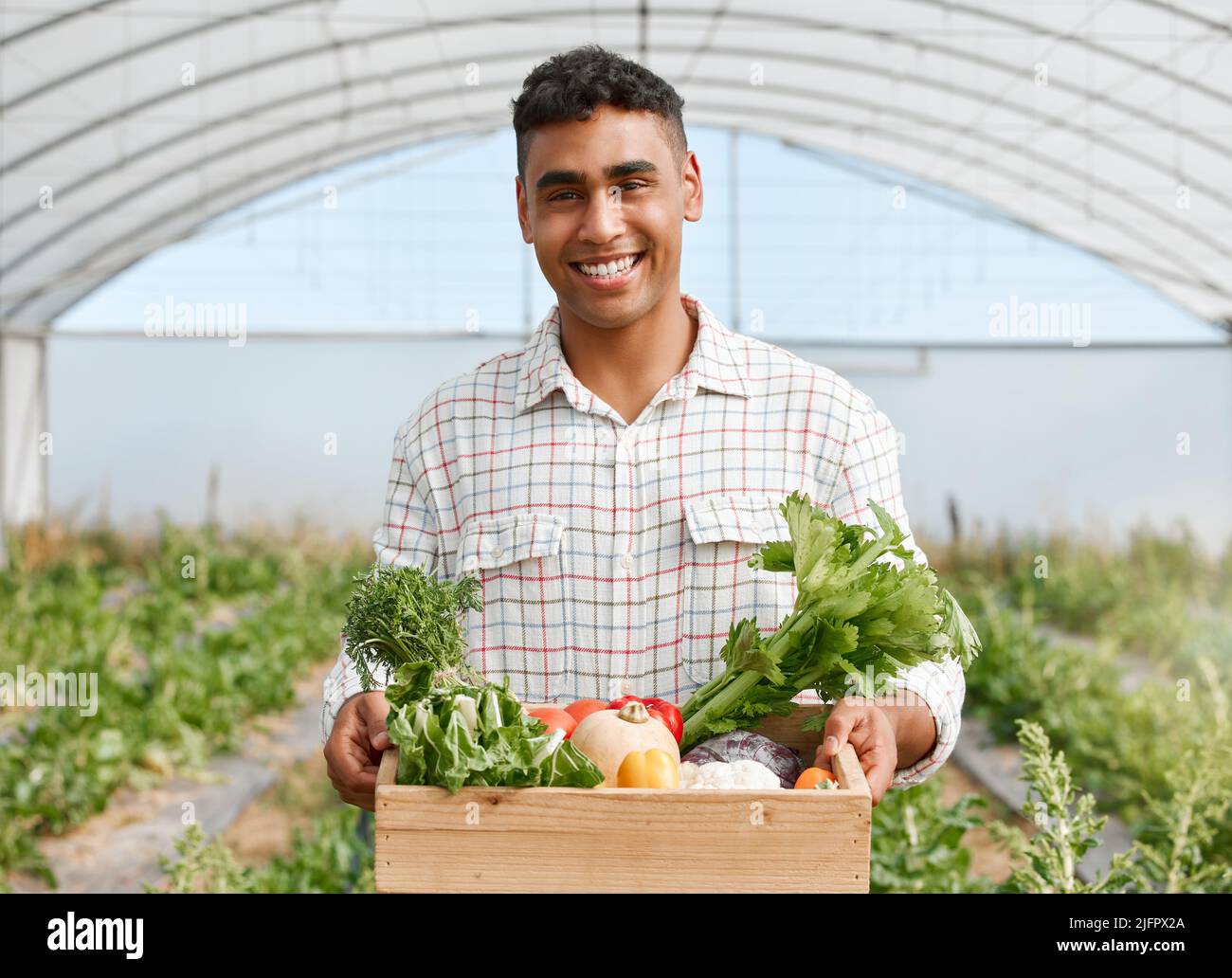 You wont taste fresher than this. Portrait of a young man holding a ...