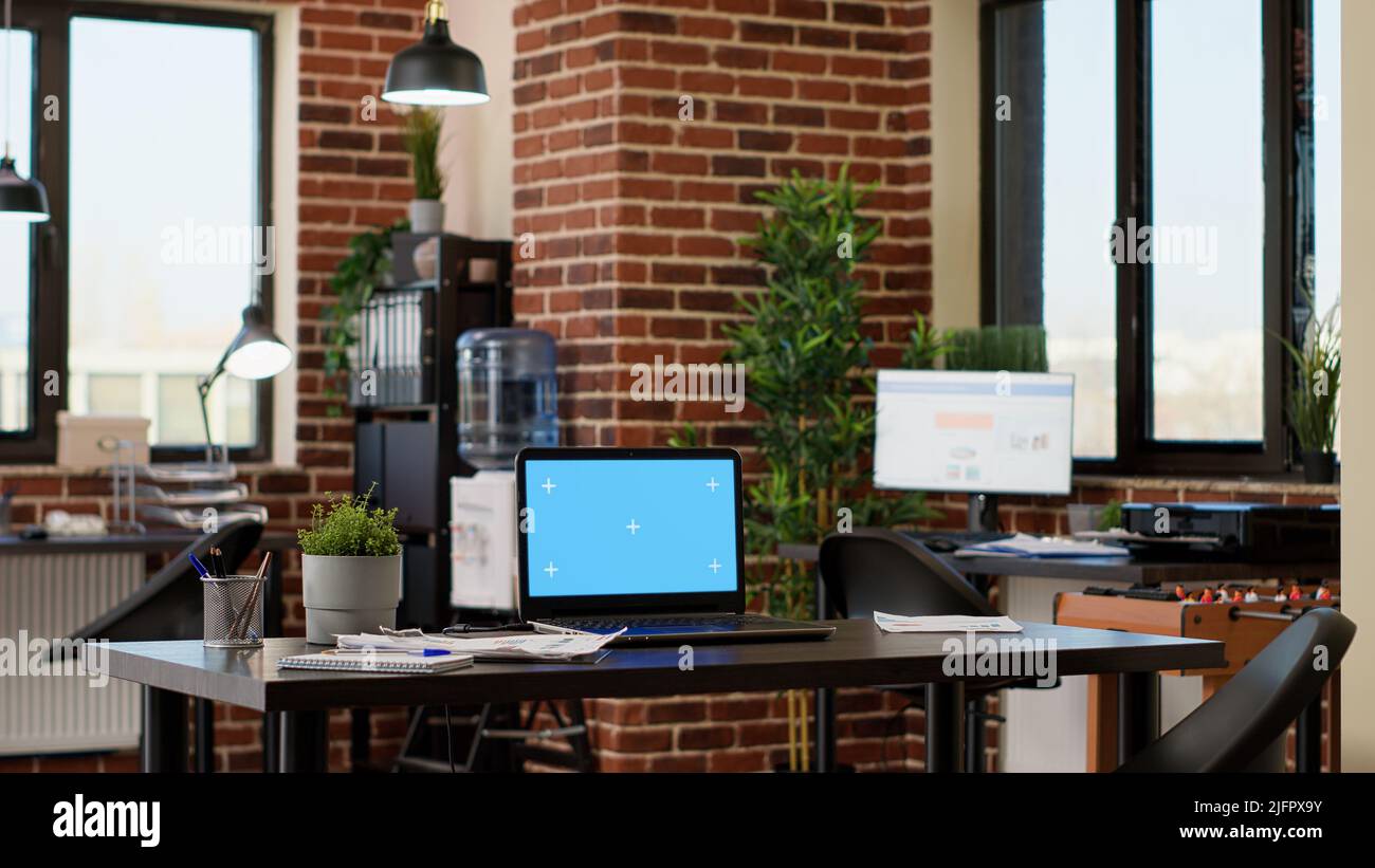 Empty business office with greenscreen on laptop computer, desk with ...
