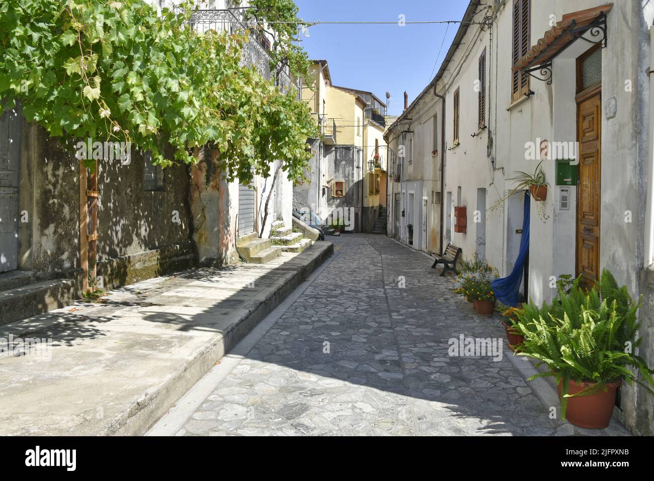 A scenic view of a narrow street and old houses in Aieta village, the ...