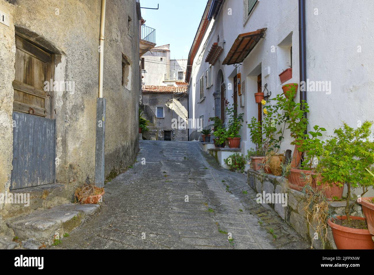A scenic view of a narrow street and old houses in Aieta village, the ...