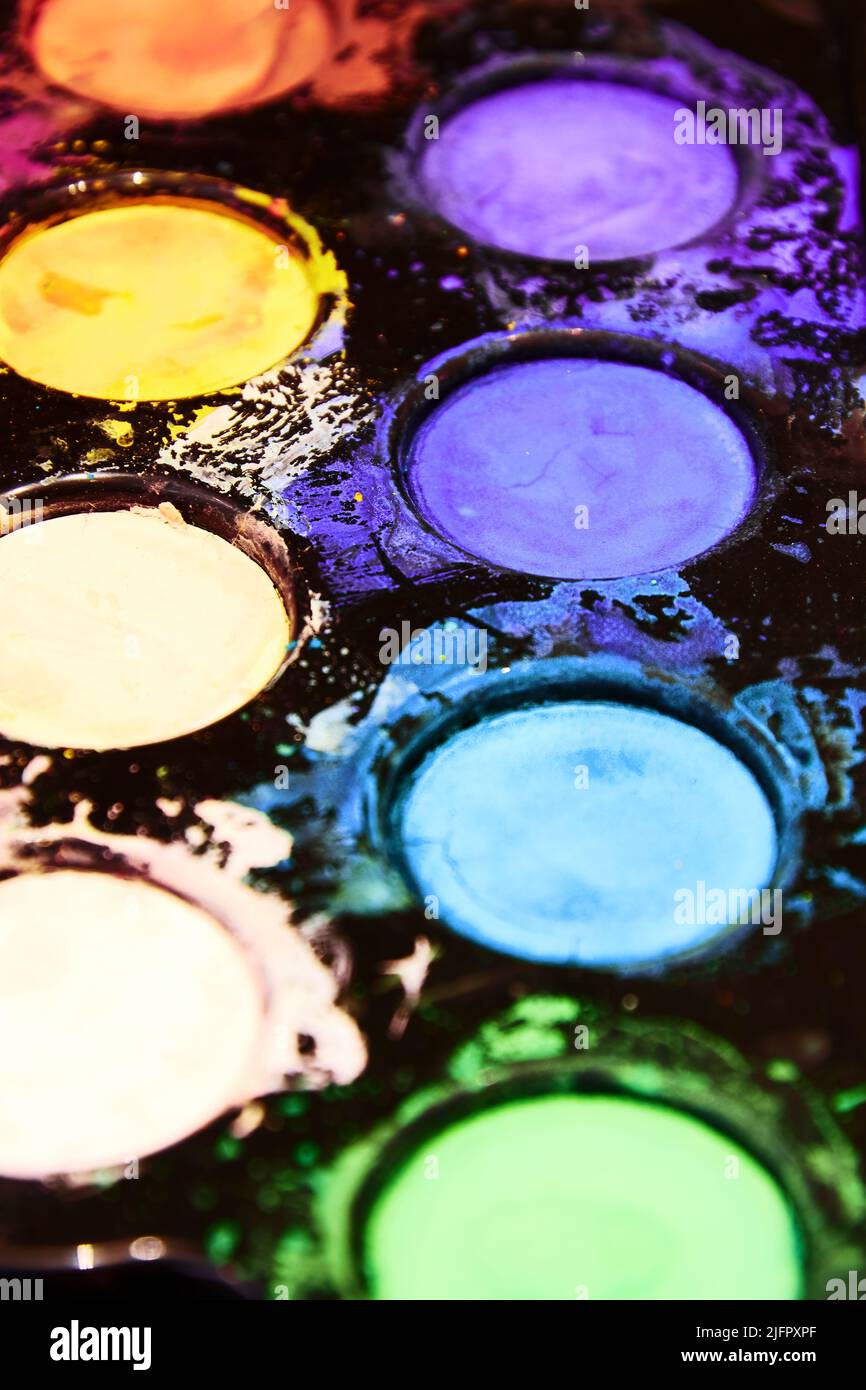 Colors splashing on the dirty artist's palette. Vertical background for ...