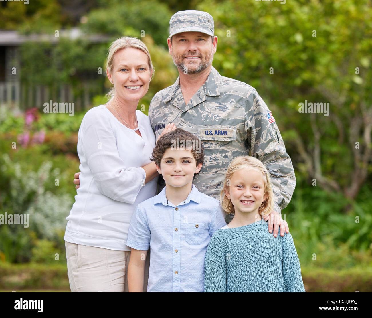 A family will always have your back. Shot of returning soldier standing ...