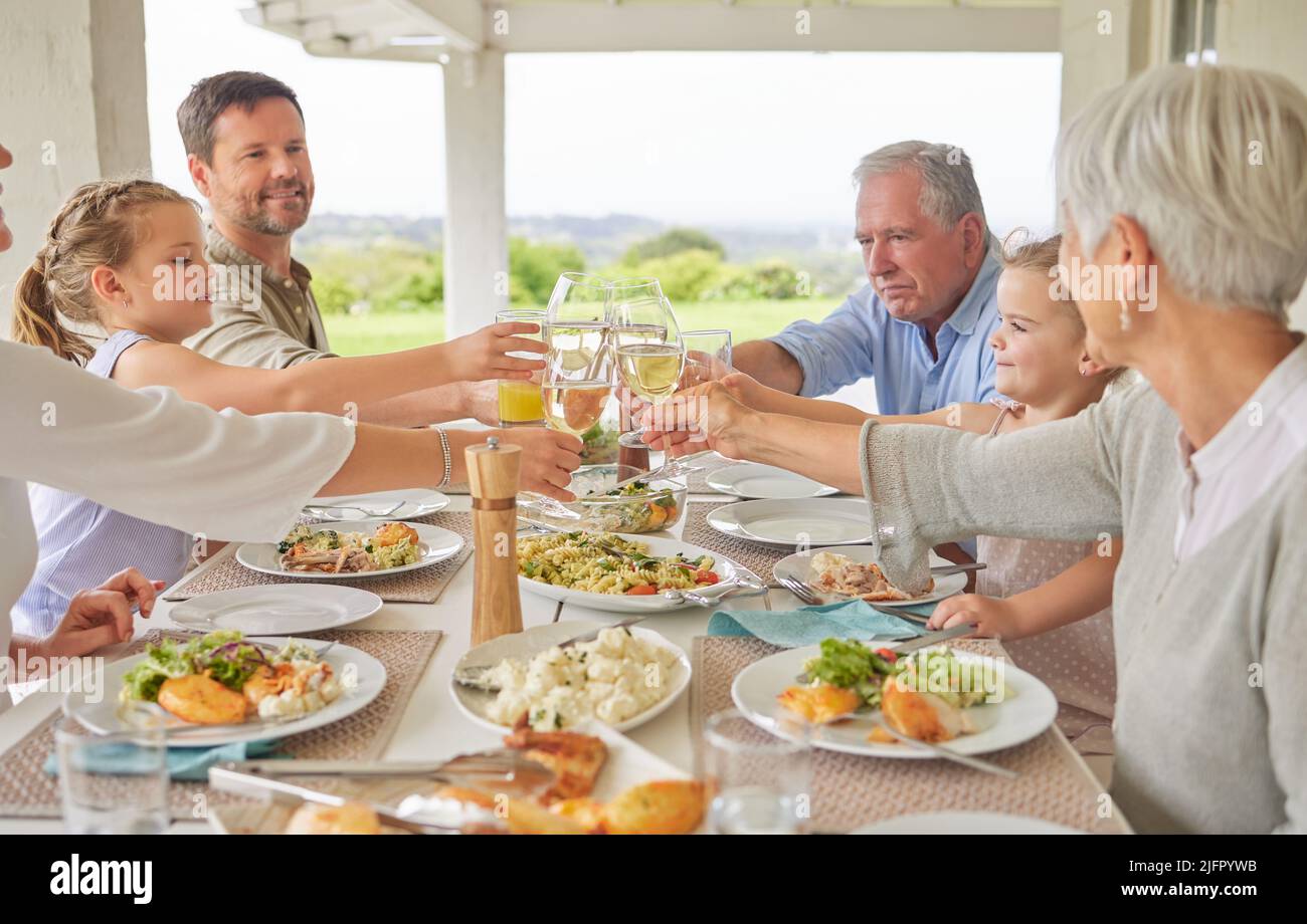 Heres to more life. Shot of a family toasting during a sunday lunch ...