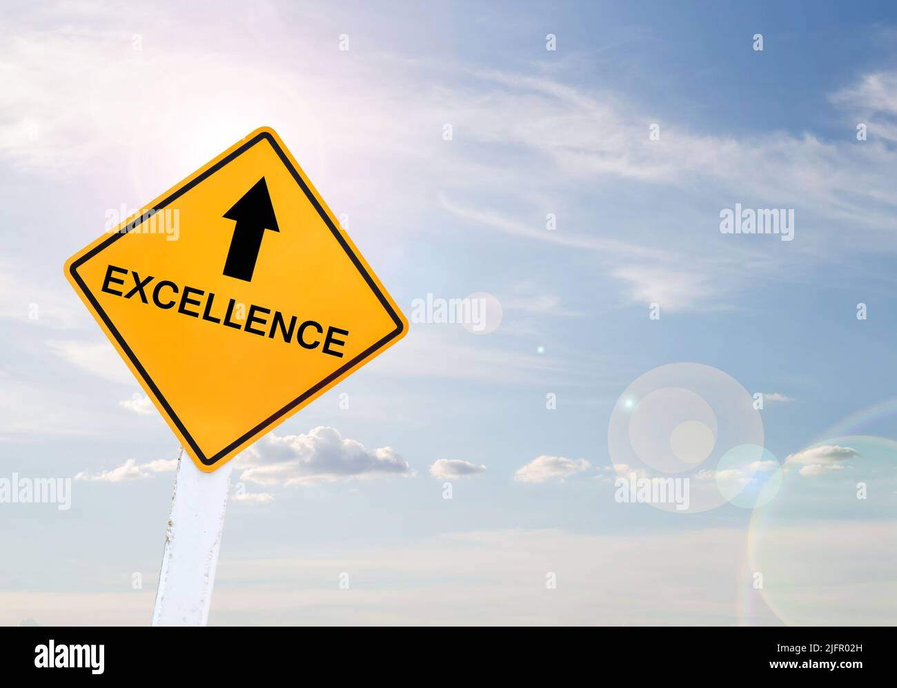 Text for EXCELLENCE on yellow road sign with blur blue sky background ...