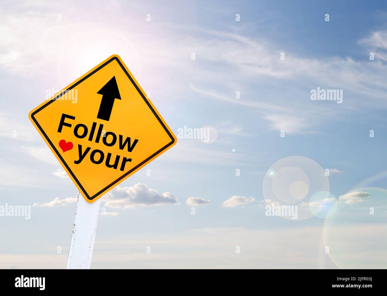 Text for Follow your hart on yellow road sign with blur blue sky ...