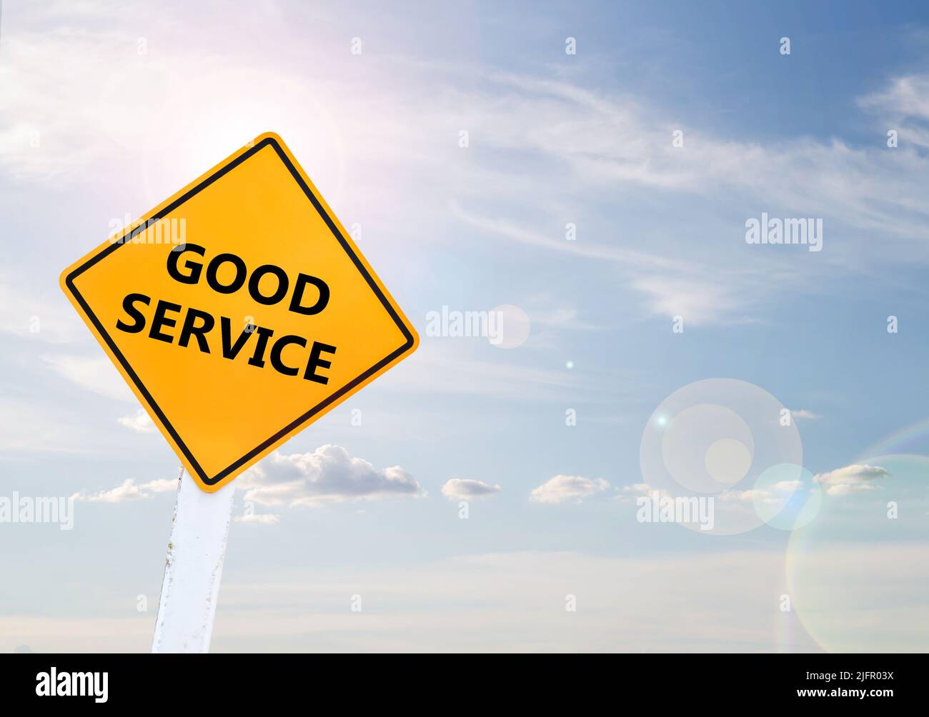 Text for GOOD SERVICE on yellow road sign with blur blue sky background ...