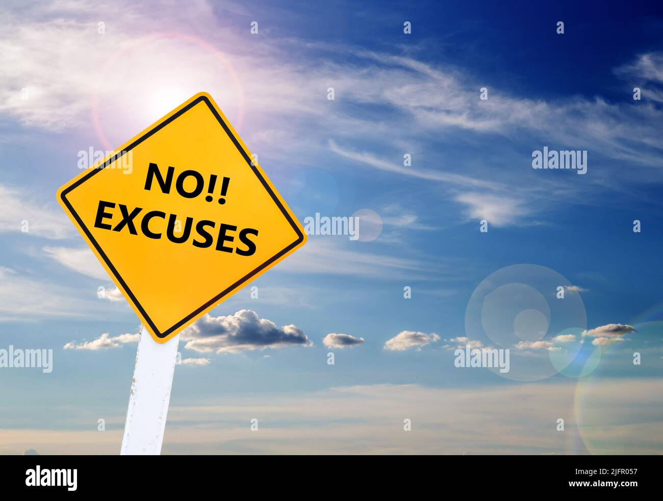 Text for ON EXCUSES on yellow road sign with blur blue sky background ...