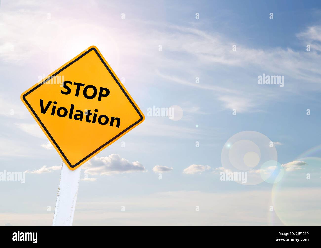 Text for STOP Violation on yellow road sign with blur blue sky ...