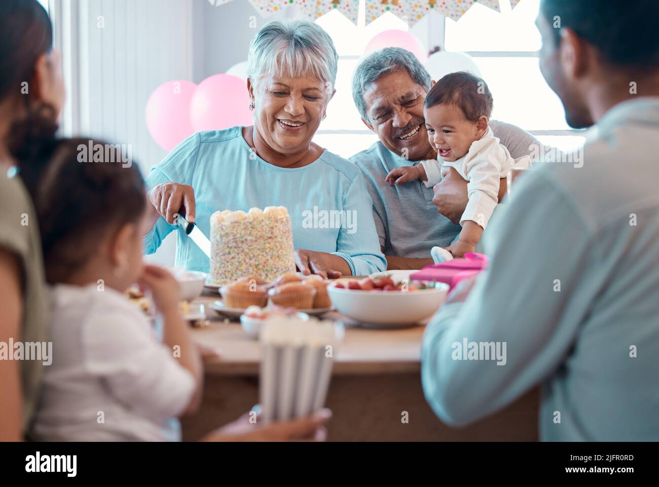 Love is sharing. Shot of a family celebrating a birthday together at ...