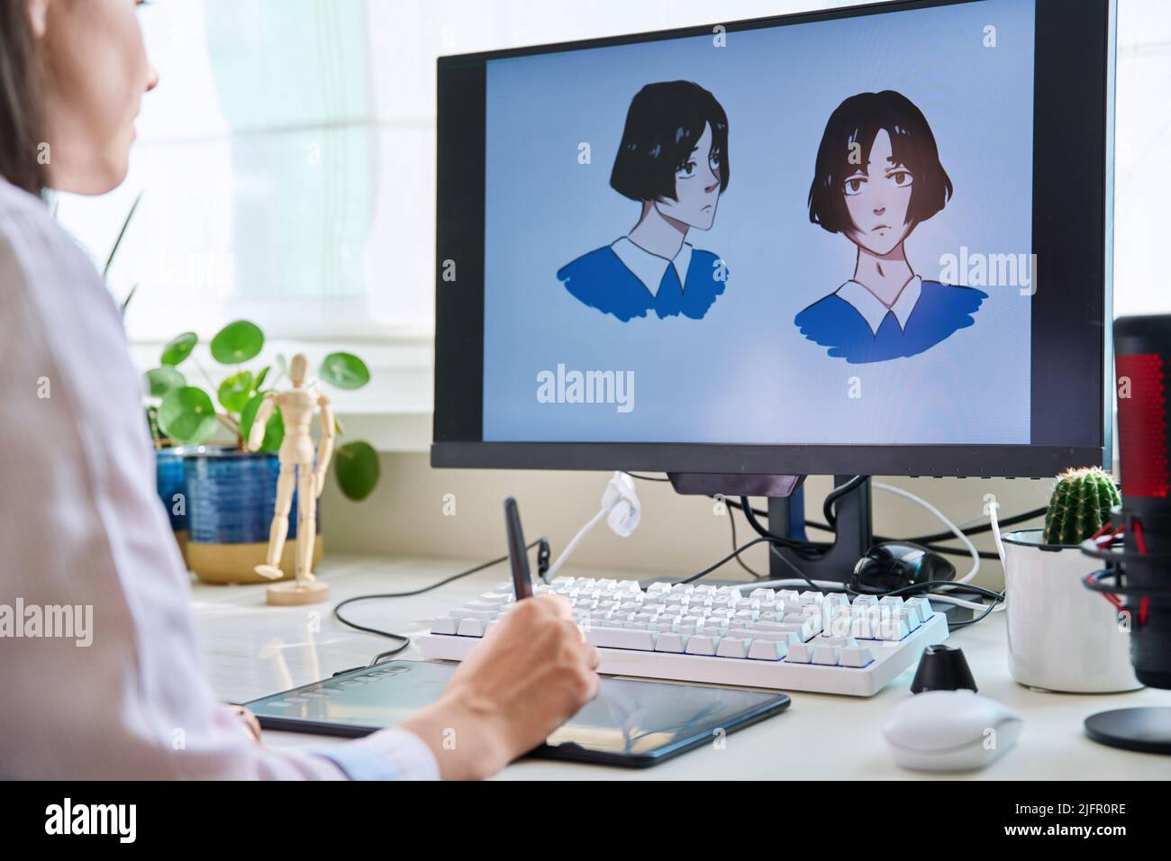 Young female graphic designer drawing sketch on graphics tablet Stock ...
