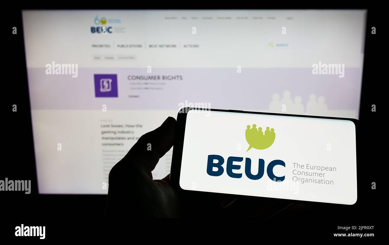 Person holding mobile phone with logo of Bureau Europeen des Unions de ...