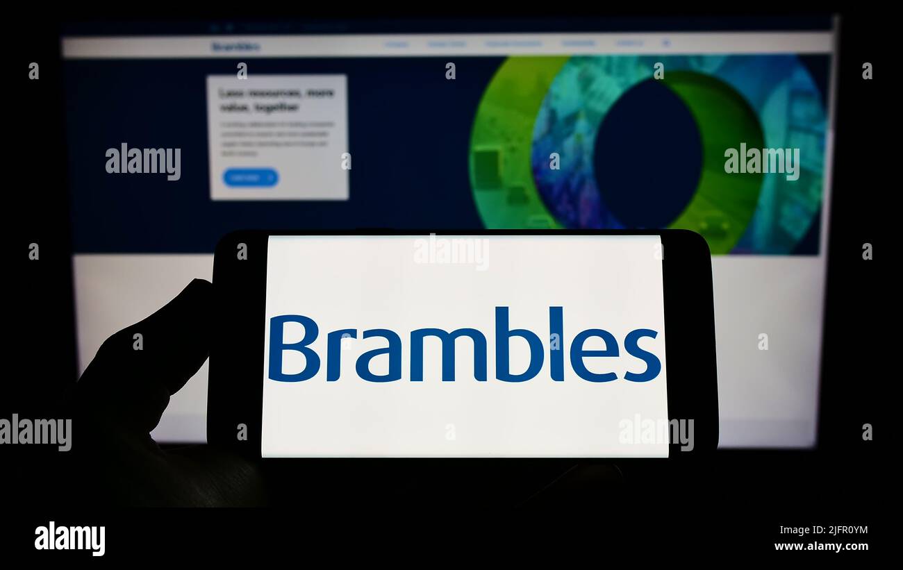 Person holding smartphone with logo of Australian services company ...