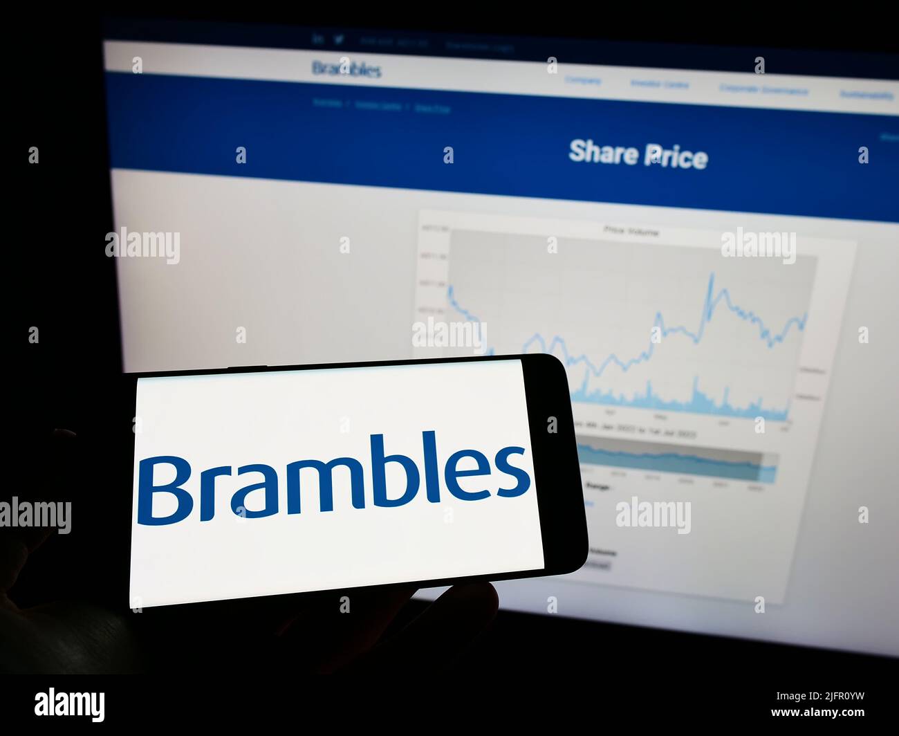 Person holding mobile phone with logo of Australian services company ...