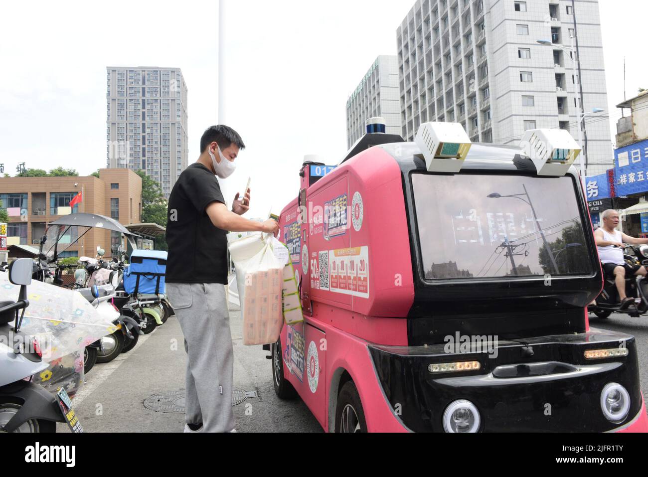 HEFEI, CHINA - JULY 5, 2022 - A supermarket worker scans a QR code to ...