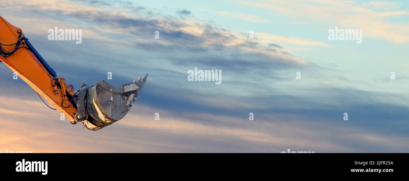 Excavator bucket on blue sky background banner, Industrial excavator ...
