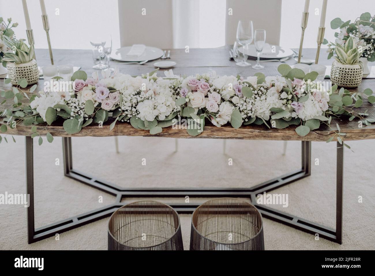 A high-angle look at the decorated wedding party head table -floral ...