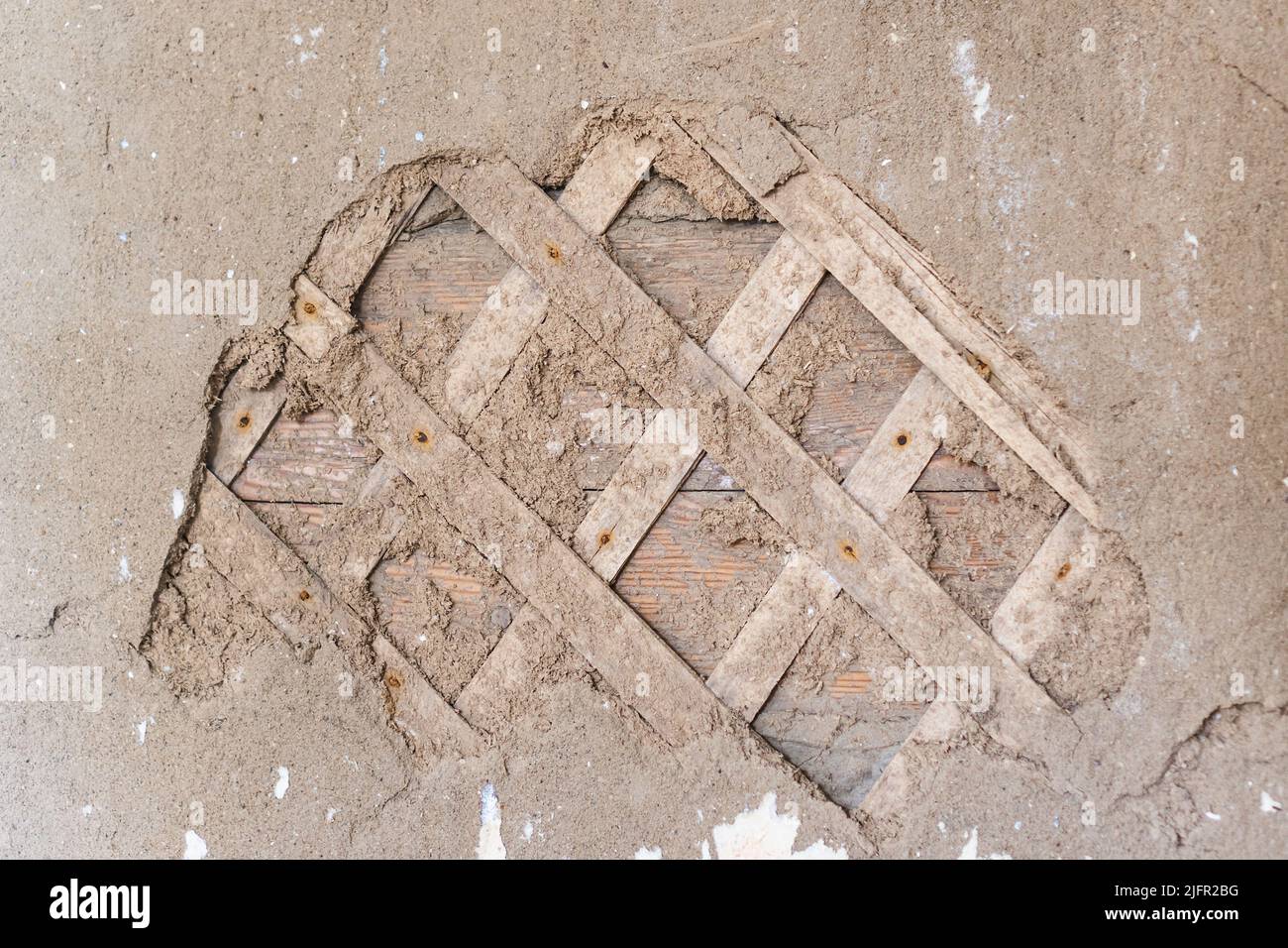 Surface of old wooden wall covered with clay plaster mixture with ...