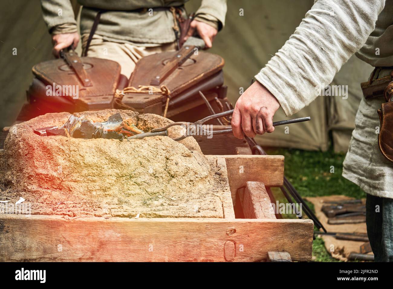 Work of a medieval blacksmith for the manufacture of metal products ...