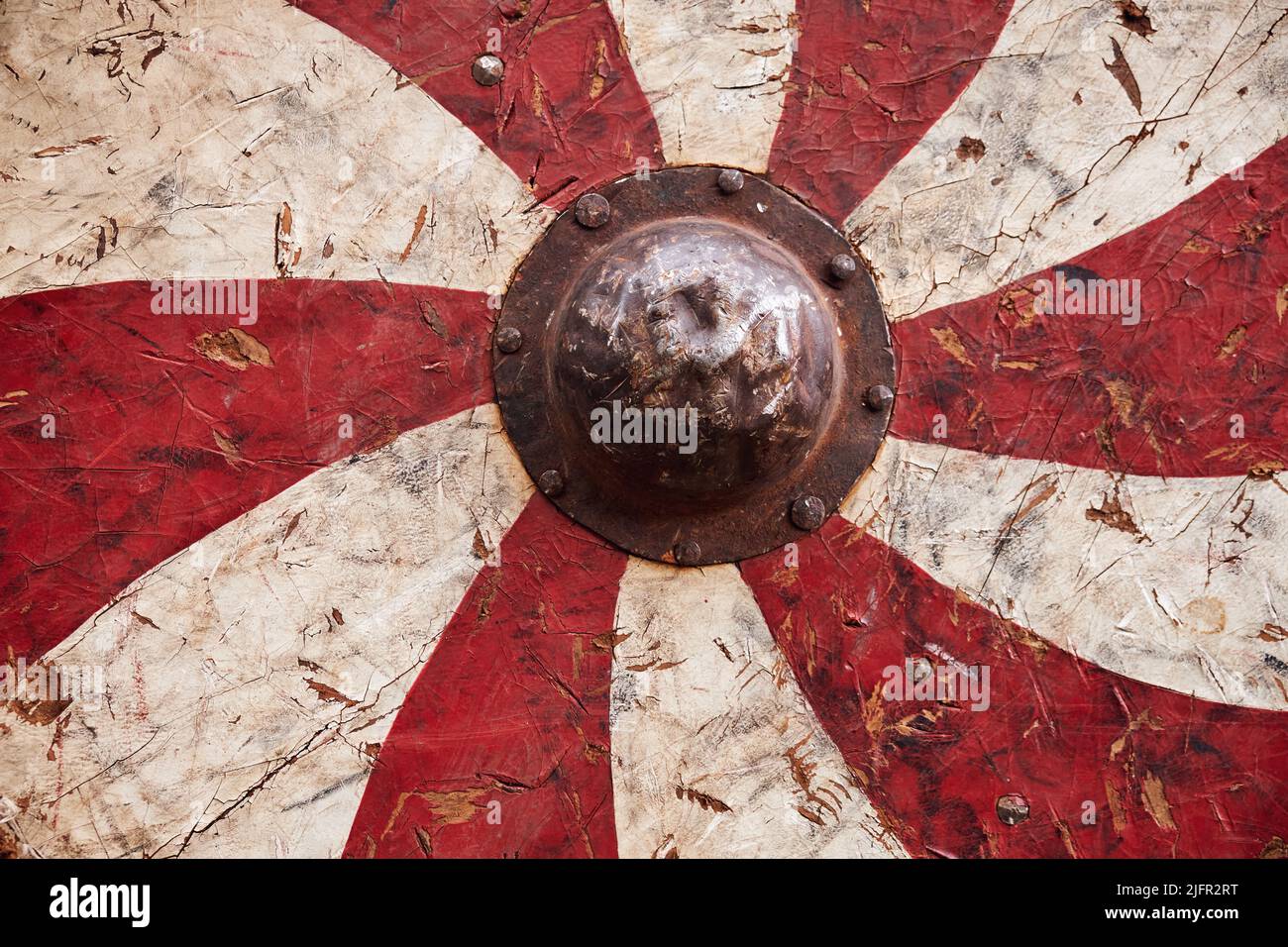 Red vintage shield with white spiral stripes a medieval warrior ...