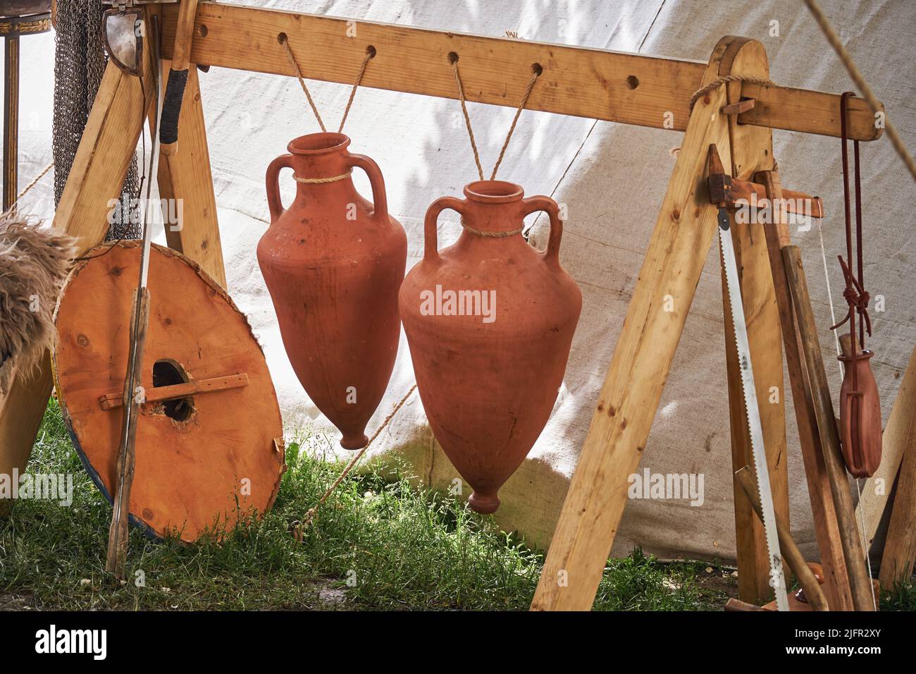 Ancient Roman camp items - jug, swords and shild. Reconstruction of ...