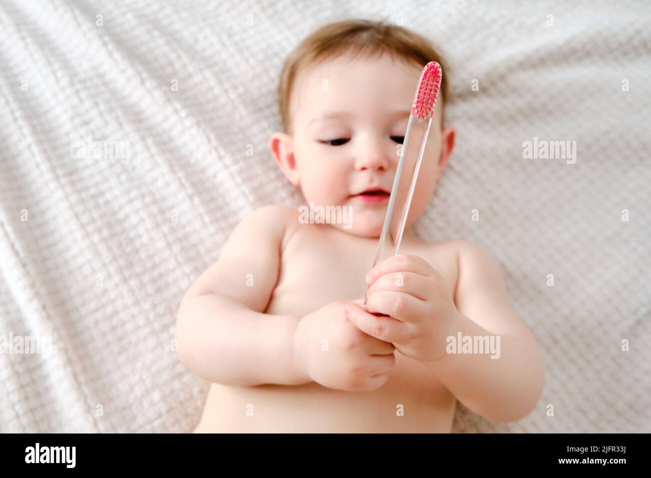 Child cleans his mouth with a toothbrush in his hands. Happy toddler ...