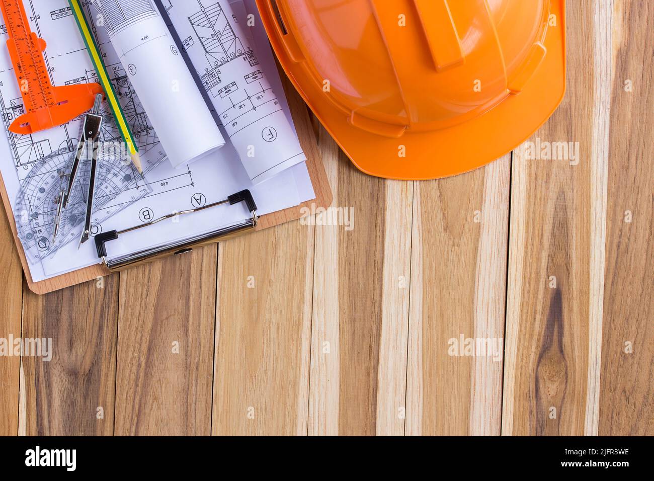 Architecture plan and rolls of blueprints with tool kit for the project ...