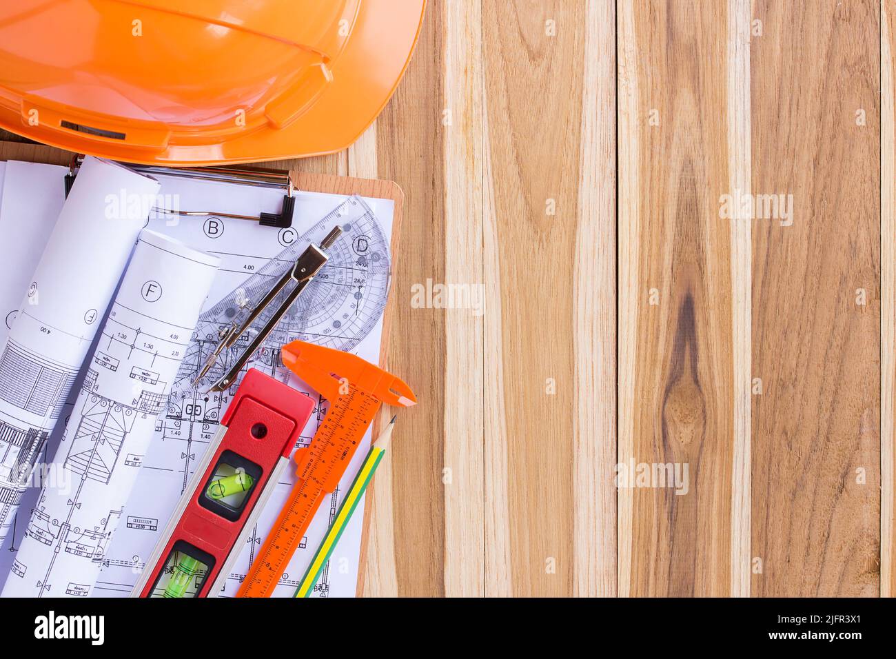 Architecture plan and rolls of blueprints with tool kit for the project ...