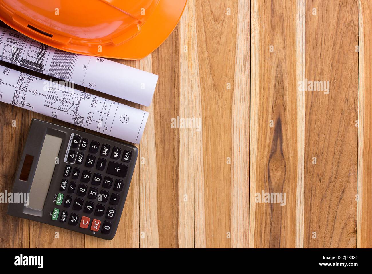 Architecture plan and rolls of blueprints with tool kit for the project ...