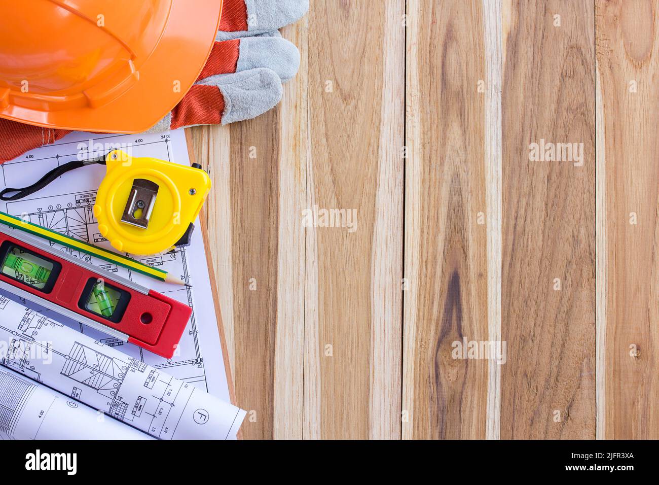 Architecture plan and rolls of blueprints with tool kit for the project ...