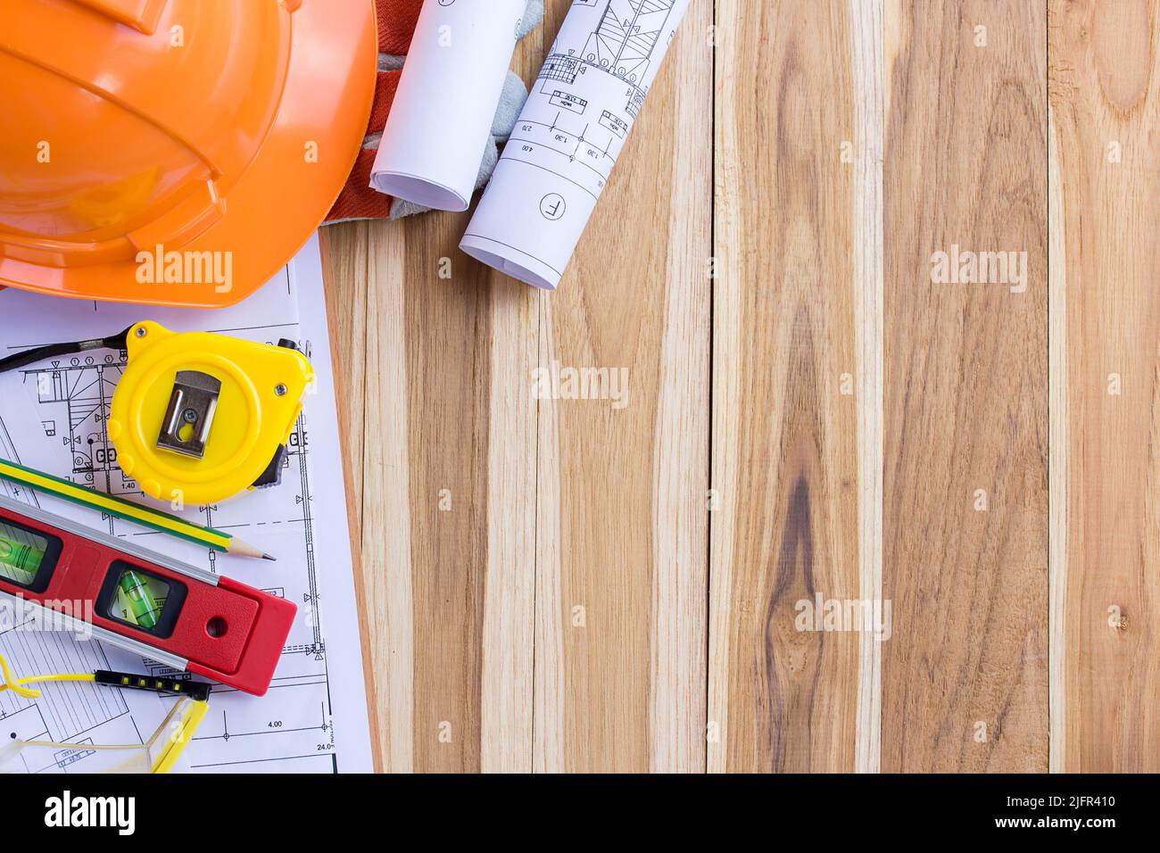 Architecture plan and rolls of blueprints with tool kit for the project ...