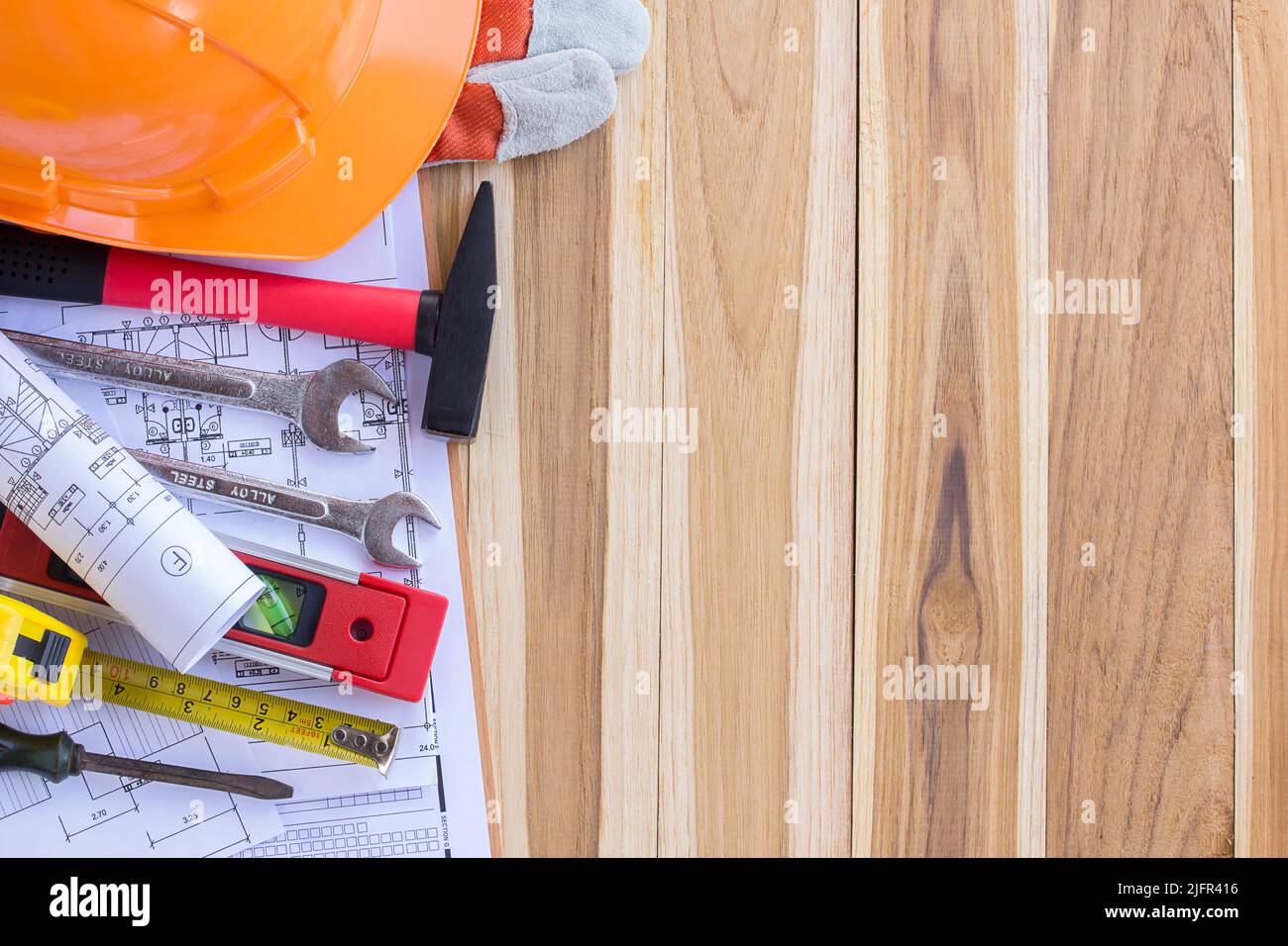 Architecture plan and rolls of blueprints with tool kit for the project ...