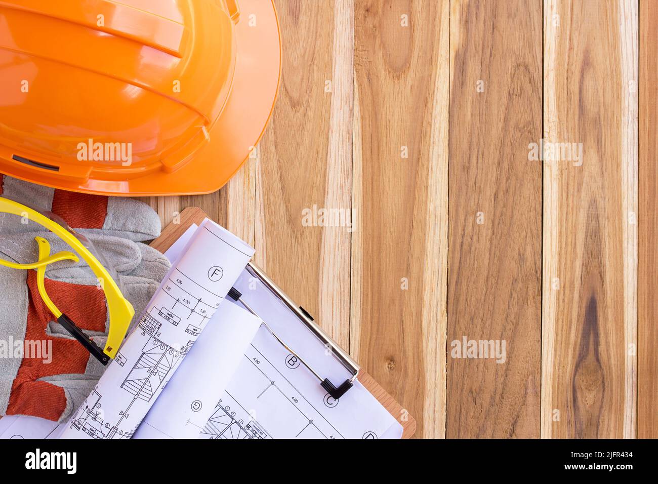 Architecture plan and rolls of blueprints with tool kit for the project ...