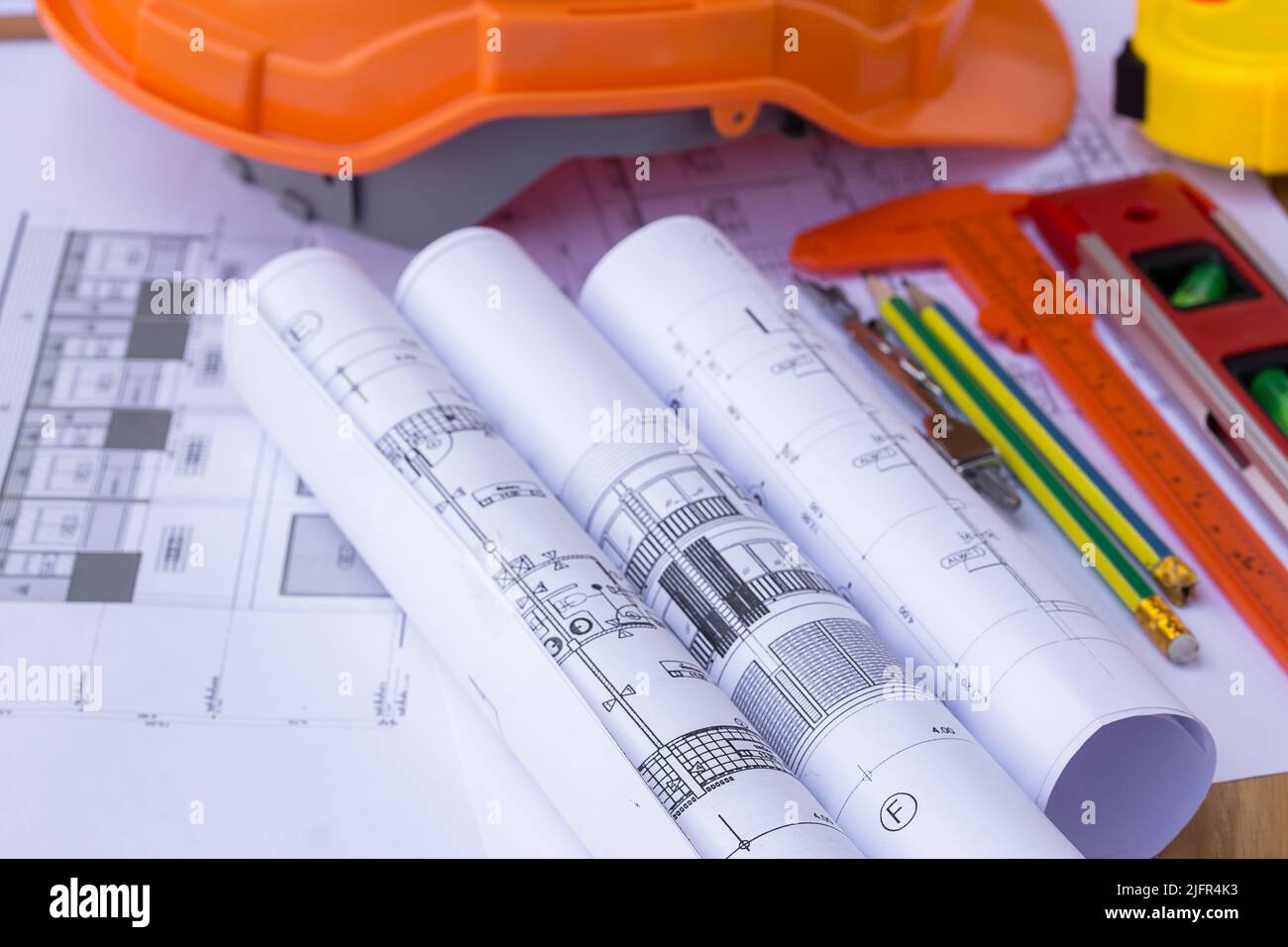 Architecture plan and rolls of blueprints with tool kit for the project ...