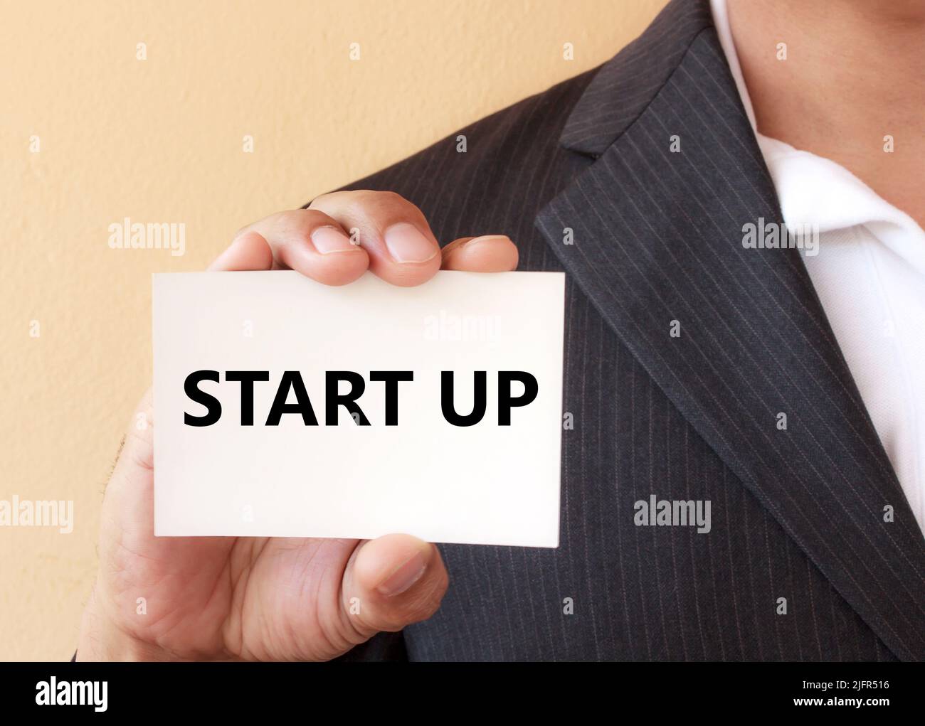 START UP word on the white card presenting by a businessman Stock Photo ...