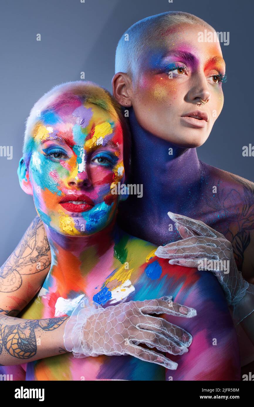 We see the world in technicolour. Studio shot of two young women posing ...
