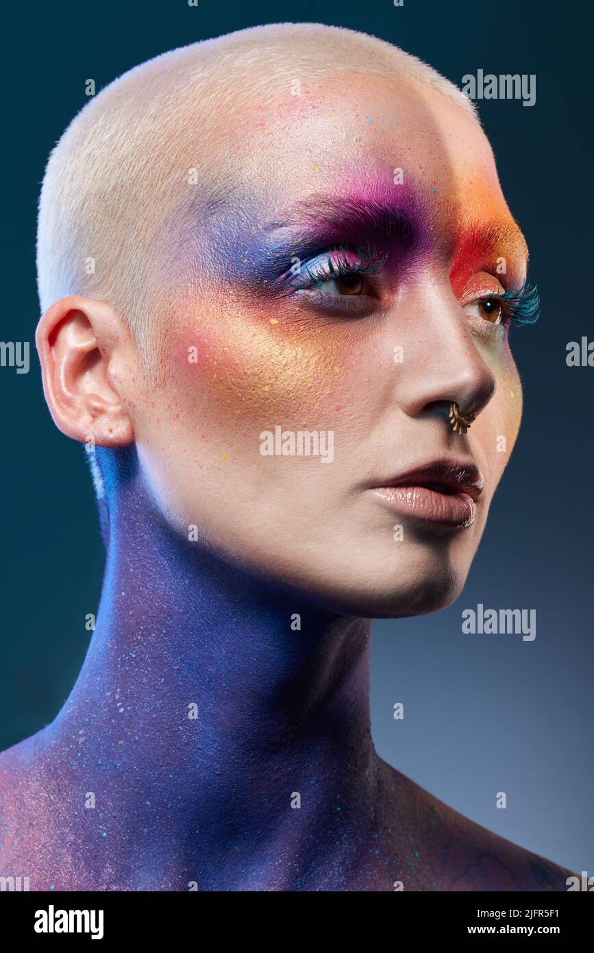 Colour your world. Studio shot of a young woman posing with multi ...