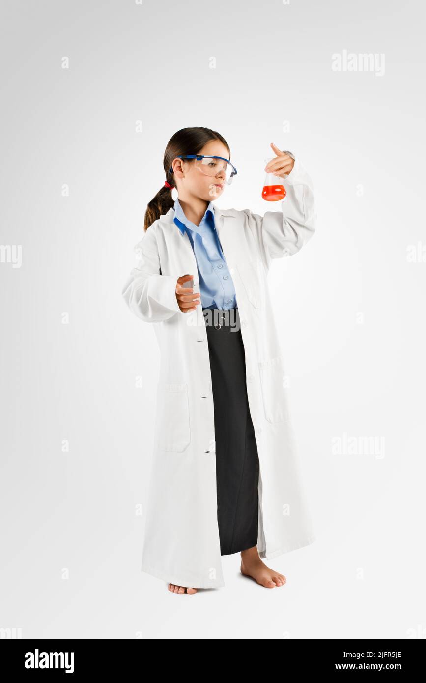 Chemistry here I come. Studio shot of an adorable little girl dressing ...