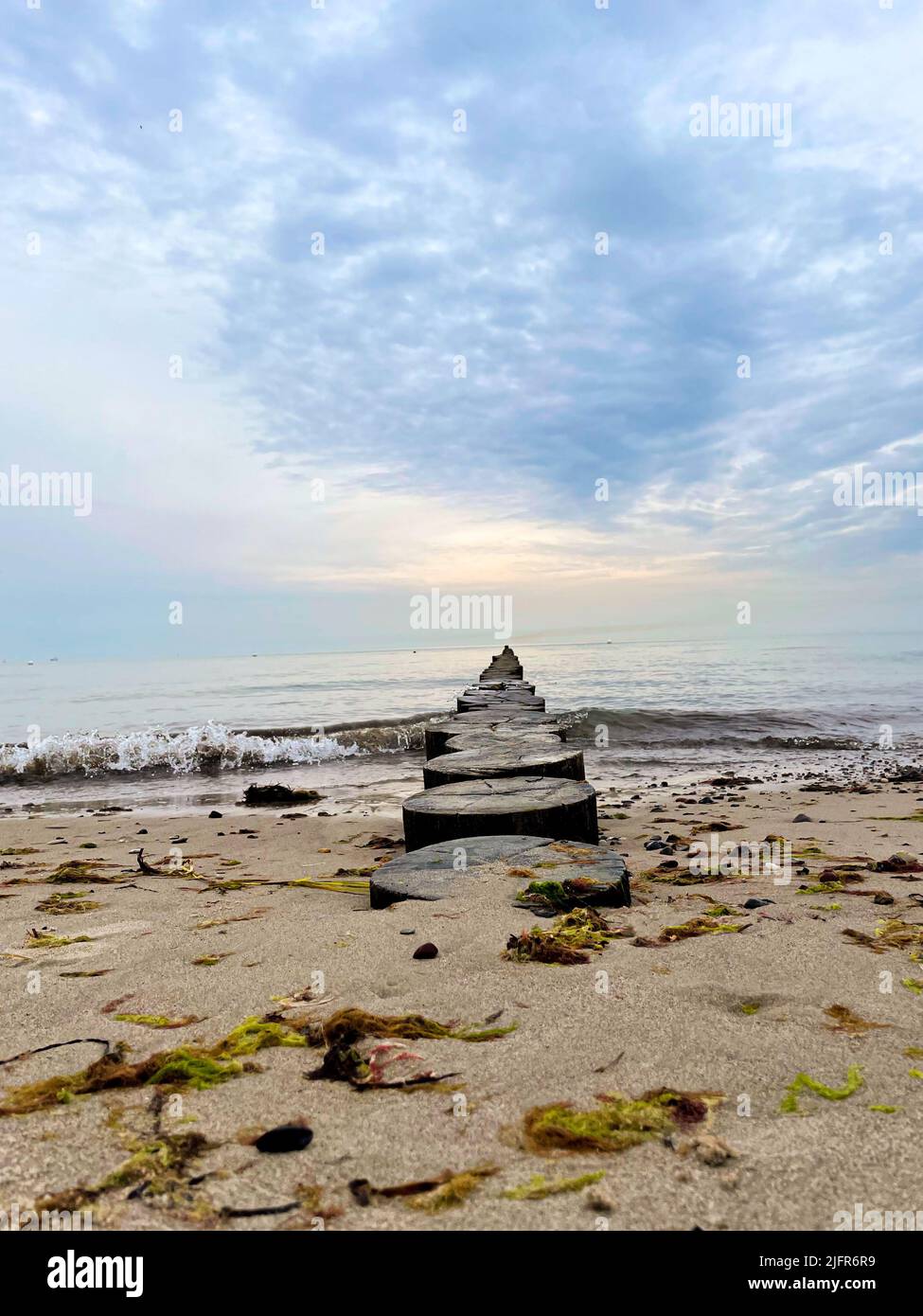 A beautiful view of the breakwater on seashore from wooden logs with ...