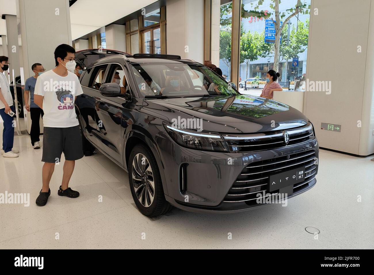 Customers check out huawei's newly released AITO M7 model at huawei's ...