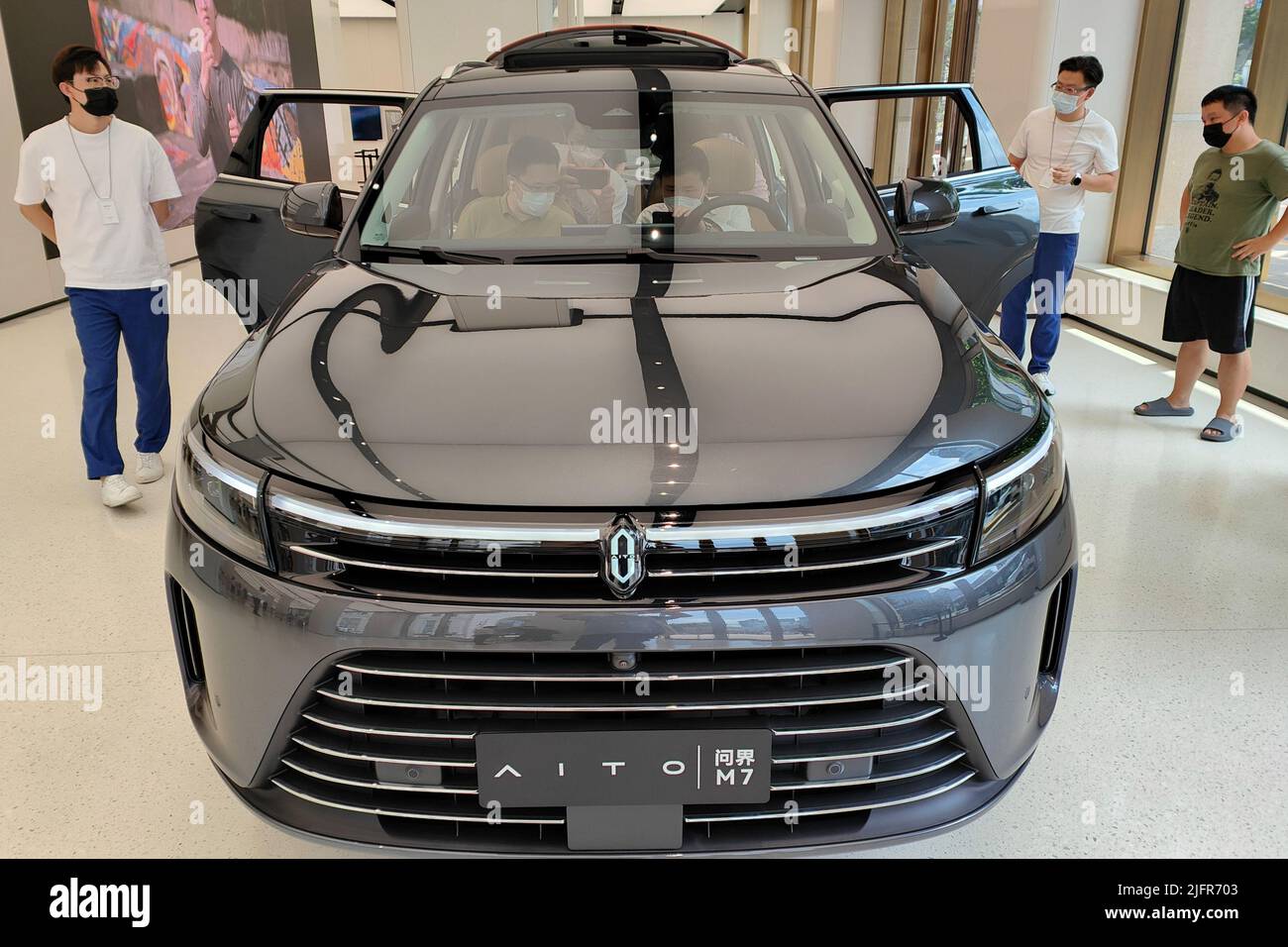 Customers check out huawei's newly released AITO M7 model at huawei's ...