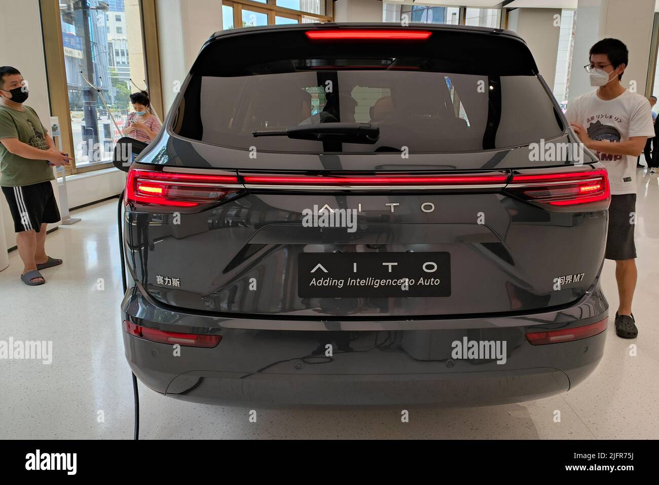 Customers check out huawei's newly released AITO M7 model at huawei's ...