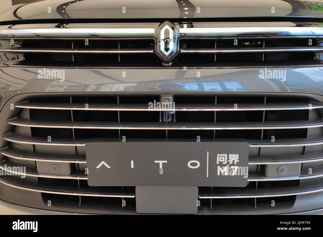 Customers check out huawei's newly released AITO M7 model at huawei's ...