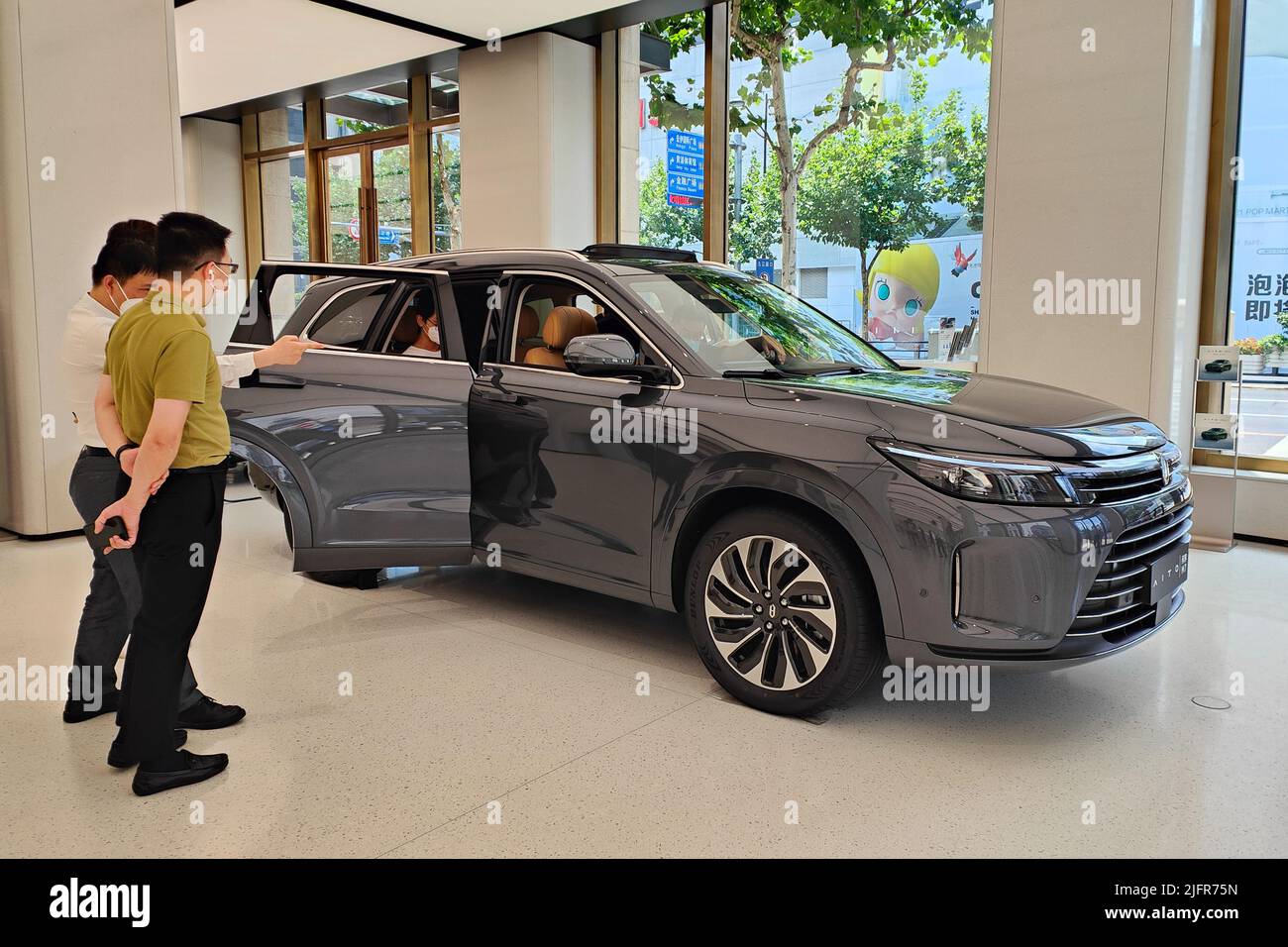 Customers check out huawei's newly released AITO M7 model at huawei's ...