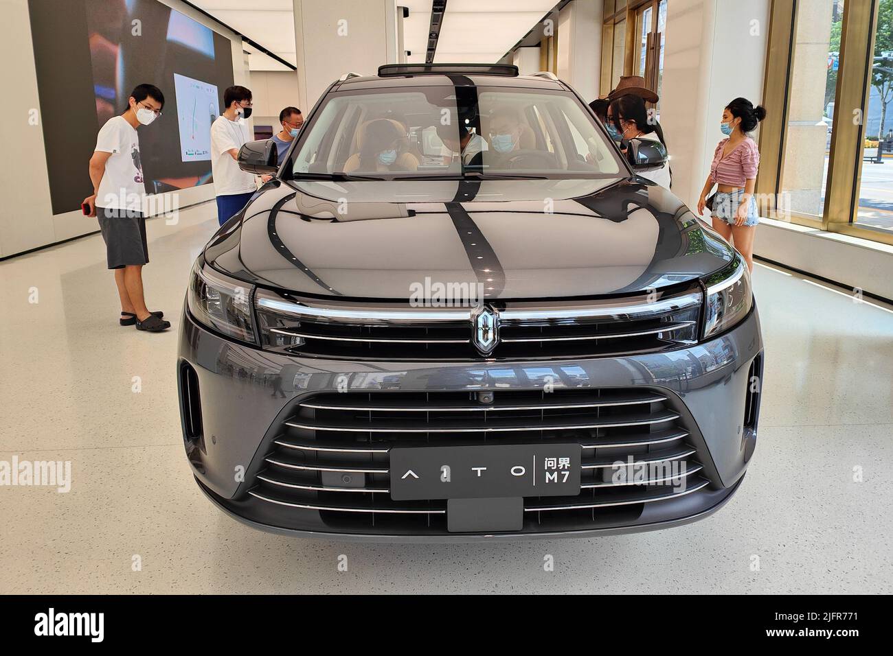 Customers check out huawei's newly released AITO M7 model at huawei's ...