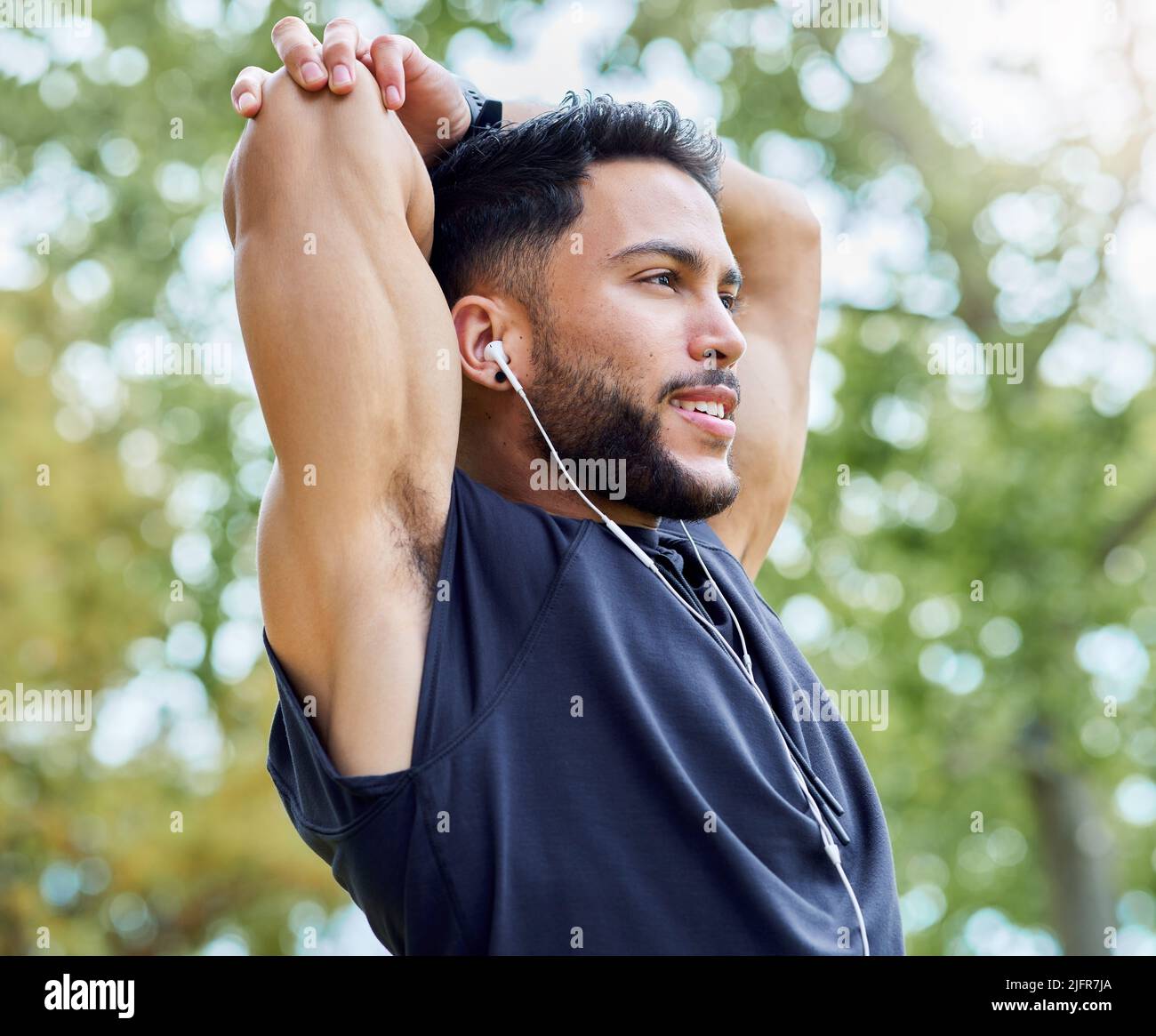 Getting mind and body ready. Shot of a sporty young man stretching his ...