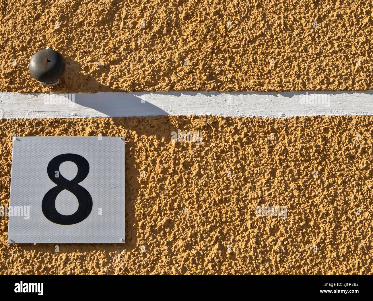 Number 8 on a wall Stock Photo - Alamy