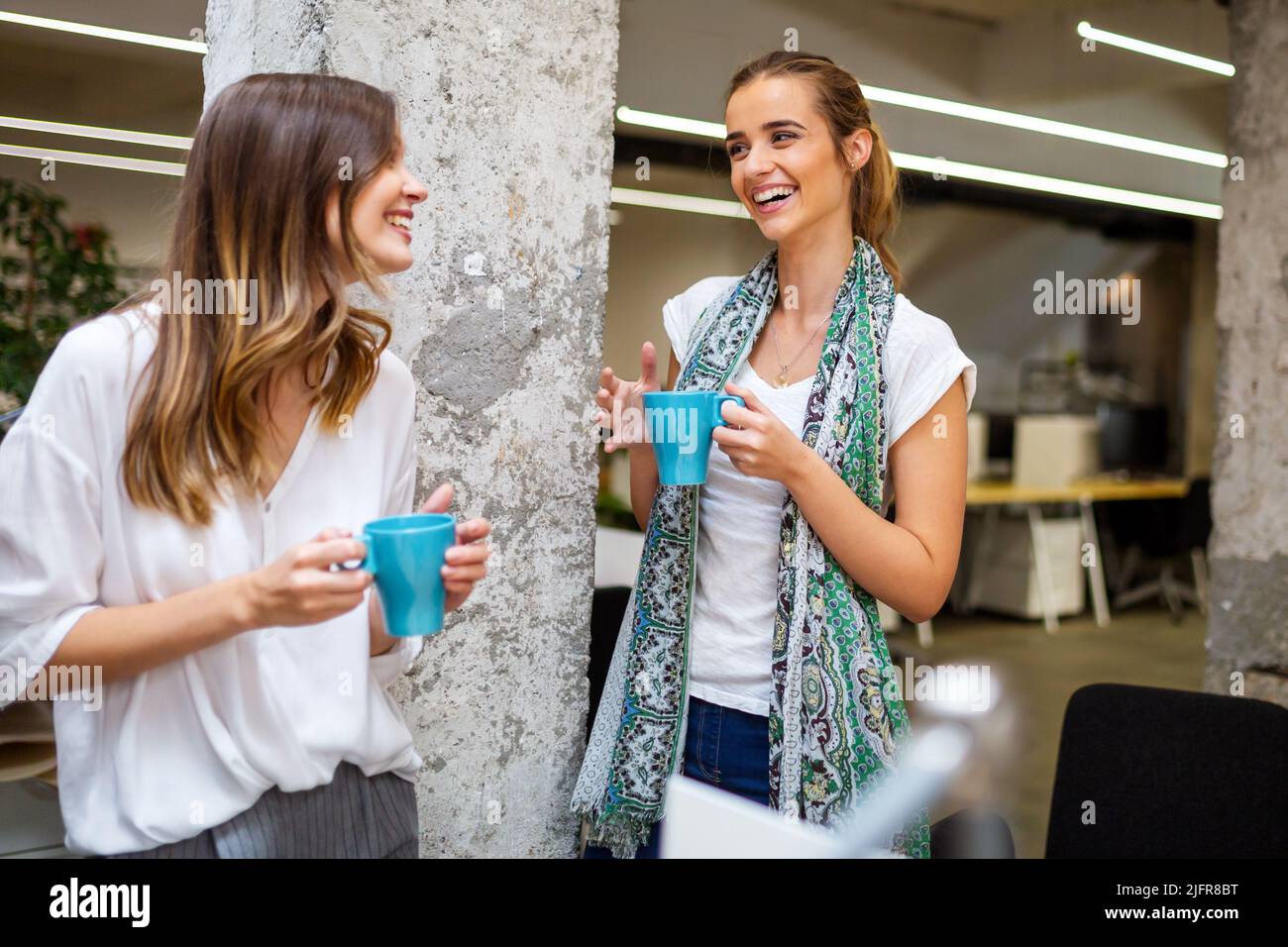 Office coffee break with two business female colleagues having fun ...