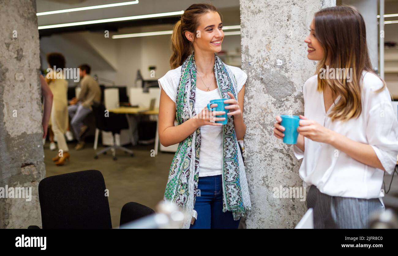 Office coffee break with two business female colleagues having fun ...