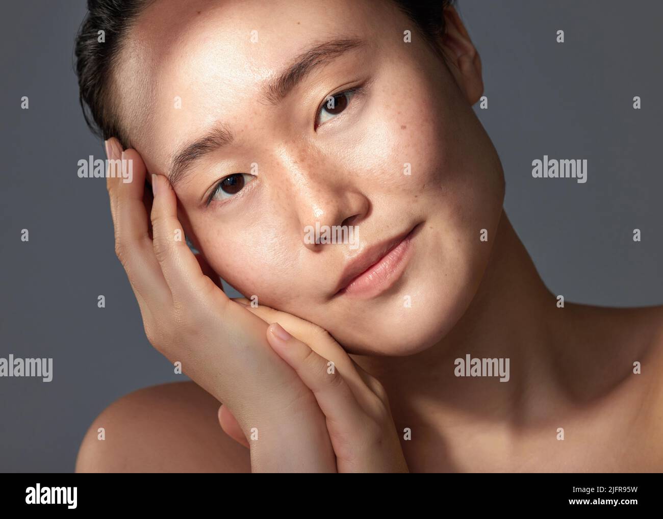Her skin looks soft, supple and radiant. Studio shot of a beautiful ...